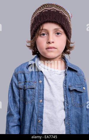 Little fashion boy posing over grey background Stock Photo - Alamy