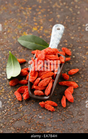 useful red goji berries on a old iron background Stock Photo - Alamy