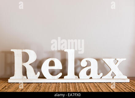 Relax written in large wooden letters with copy space Stock Photo - Alamy