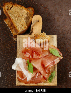Smoked Parma ham on a wooden board Stock Photo - Alamy