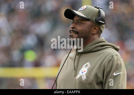 A New York Jets player looks at a Microsoft tablet on the sidelines ...