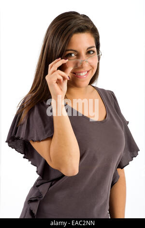 young stylish woman in eyeglasses and denim skirt standing on steps ...