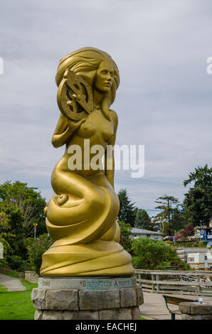 Golden mermaid statue, with the motto "Service above Self" inscribed on ...