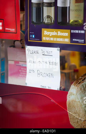Danger sign warning of broken glass on the top of a wall, England Stock ...