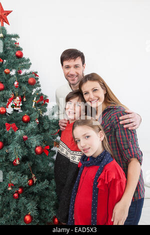 Smiling family preparing for celebration Christmas together at home ...