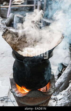 Boiling rice on an open fire in a rural indian village. Andhra Pradesh ...