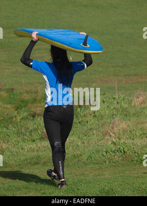 young woman from behind carrying paper shopping bags Stock Photo - Alamy