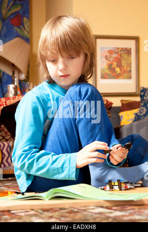 Boy Putting Together his Assembling Toys Outdoors Stock Photo - Alamy