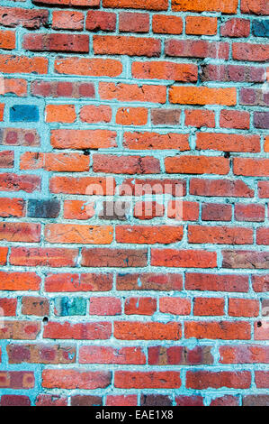A wall with the red bricks and black cement or outline that puts the ...