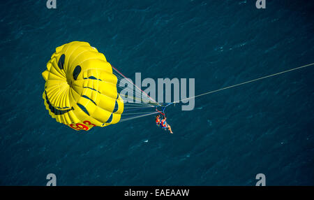 Aerial view, parasailing, parachute with a smiley face drawn by a motor ...