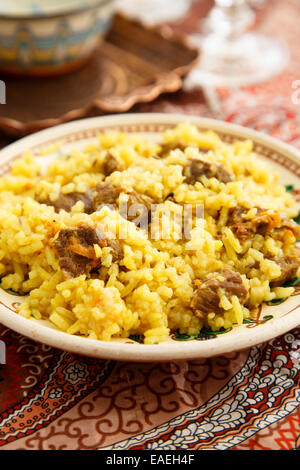 Pilaf with beef and lamb meat, vegetables in a skillet isolated on ...