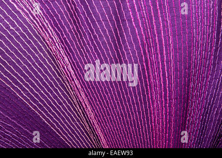 intricate colorful stitching forming pattern on mauve fabric Stock ...