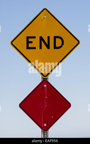 Diamond reflective red street sign for dead end with pasture and forest ...