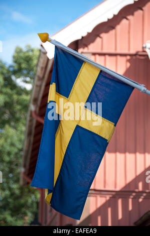 Sweden national flag waving on a Stockholm city building facade, cloudy ...