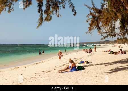 Mauritius beach; tourists sunbathing on Mont Choisy beach at the Trou ...