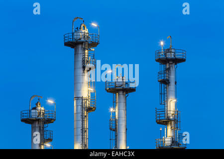 Detail of four distillation towers in a chemical plant and refinery ...