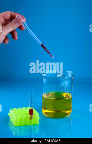 Beaker with red dye Stock Photo - Alamy