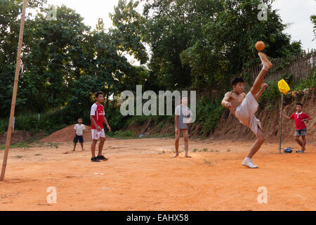 Kids playing ball, sepak takraw, in a village near Muang Ngoi Laos ...