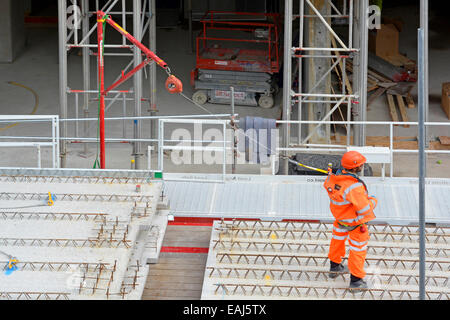 Fall prevention restraint system in use by workman on raised platform ...