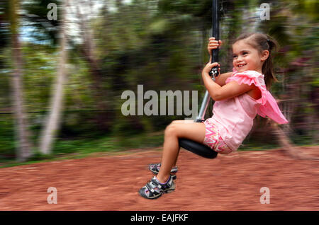 Child girl rids on Flying Fox play equipment in a children's Stock ...
