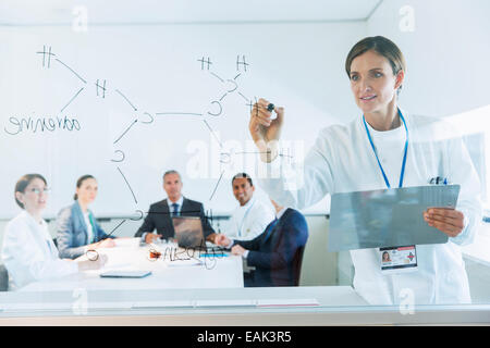 Young hispanic man drawing on notebook at art studio Stock Photo - Alamy