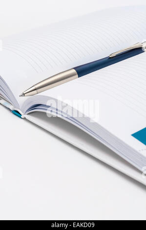 Blue pen with notebook closeup Stock Photo - Alamy