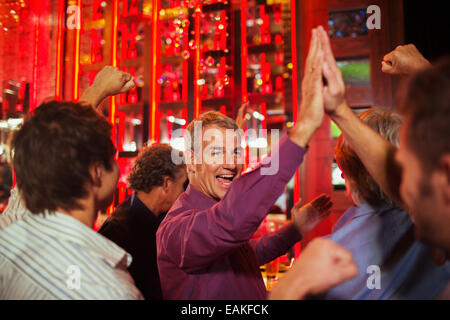 Men High-Fiving Each Other Stock Photo - Alamy