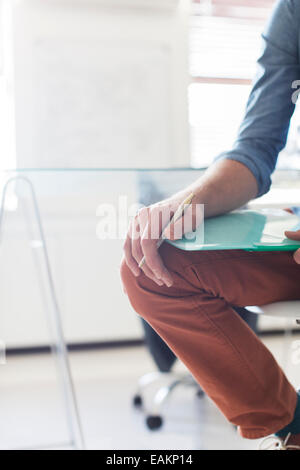Business man holding pen, business documents, reports, graphs and ...