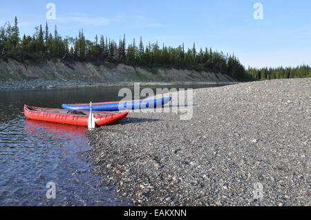 Inflatable kayaks on the shore taiga rivers. The river of the polar ...