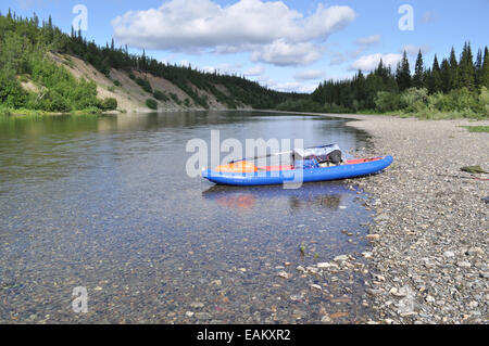 Inflatable kayaks on the shore taiga rivers. The river of the polar ...