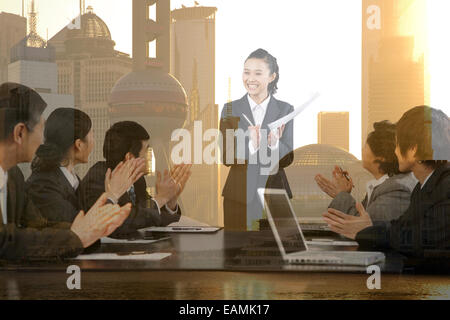 Composite image of portrait of successful businesswoman with clenched ...