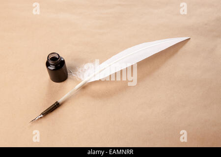 High angle shot of old quill and ink well on wooden writing desk Stock ...