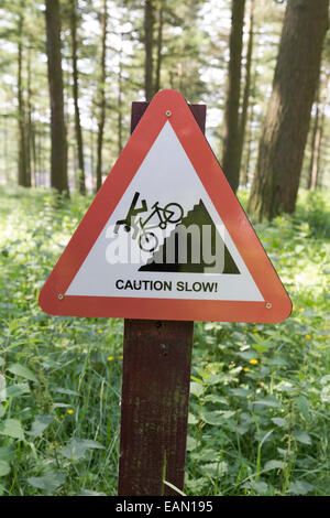 Steep slope slow down sign for cyclists on a public footpath Stock ...