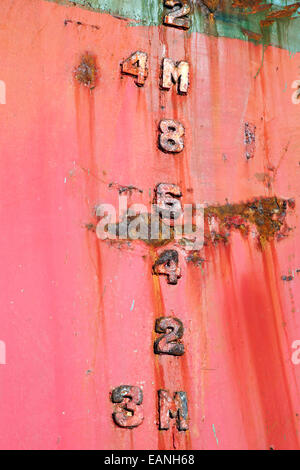 Depth markers on rusty hull of beached ship wreck Stock Photo - Alamy