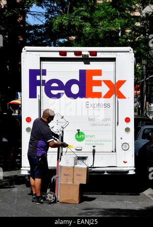FedEx worker prepares packages for delivery in Chelsea in New York on ...