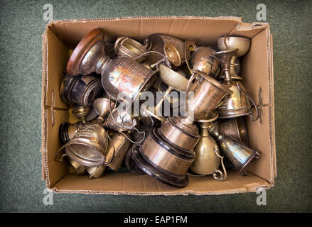 A cardboard box full of old school cups and trophies UK Stock Photo - Alamy