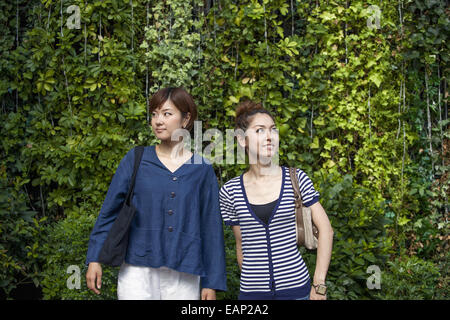 Two women standing side by side Stock Photo - Alamy