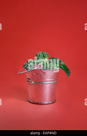 Green broccoli in red bucket Stock Photo - Alamy