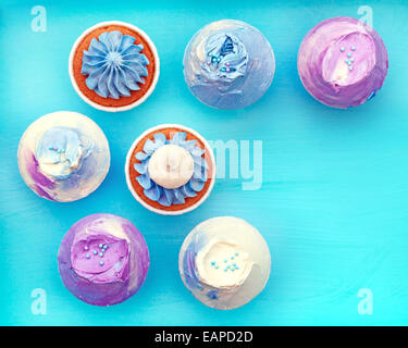 Delicious sweet buffet with magenta cupcakes on cyan background Stock ...