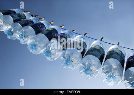 plastic spring water bottles pegged diagonally to clothes line Stock ...