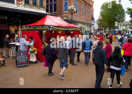 People queuing at street food stalls on Strutton Ground market ...