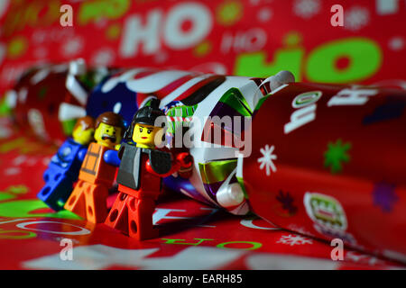 Lego figures pushing a Christmas cracker Stock Photo - Alamy
