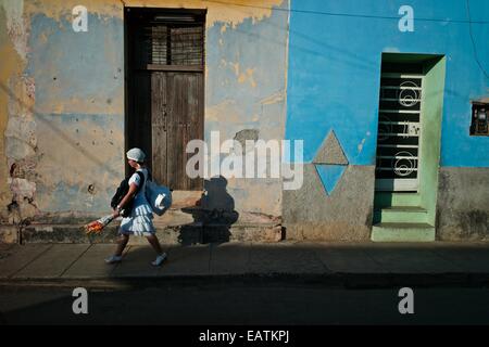 A Santera dressed in white carrying flowers Stock Photo - Alamy