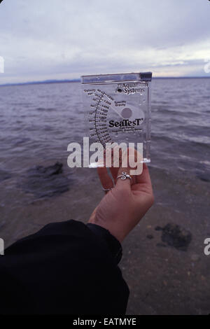 Researcher measuring water salinity San Ignacio Lagoon Baja California ...