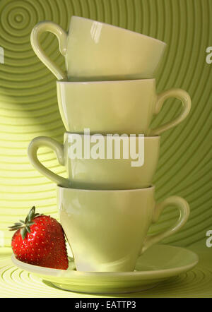 A vertical shot of a red mug with a saucer on a red background Stock ...