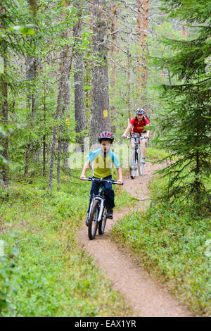 One caucasian children rides bike road in autumn park. Little girl ...
