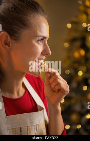 Happy young woman eating walnuts in kitchen Stock Photo - Alamy
