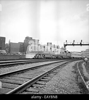 Passenger train departs from the station at sunset time Stock Photo - Alamy