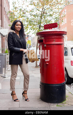 Woman posting a letter Stock Photo - Alamy