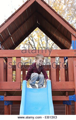 young boy sliding down a slide on his belly Stock Photo: 71670343 - Alamy